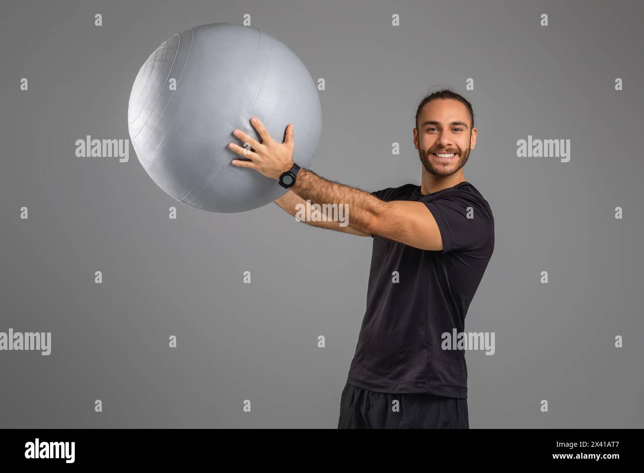 Man Holding Exercise Ball in Front of Face Stock Photo - Alamy