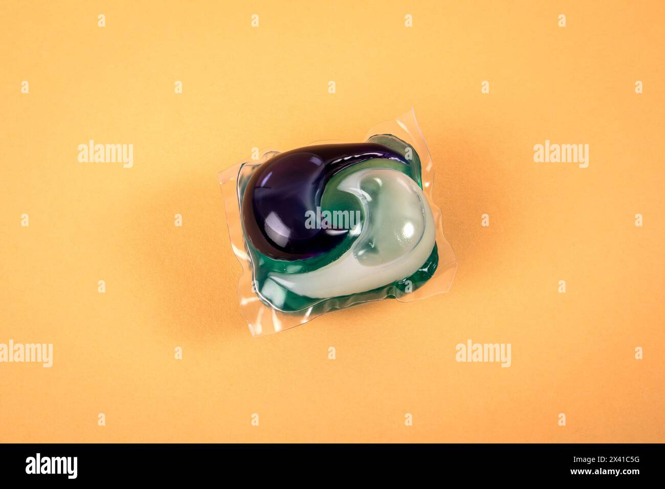One laundry capsule on a light background Stock Photo - Alamy