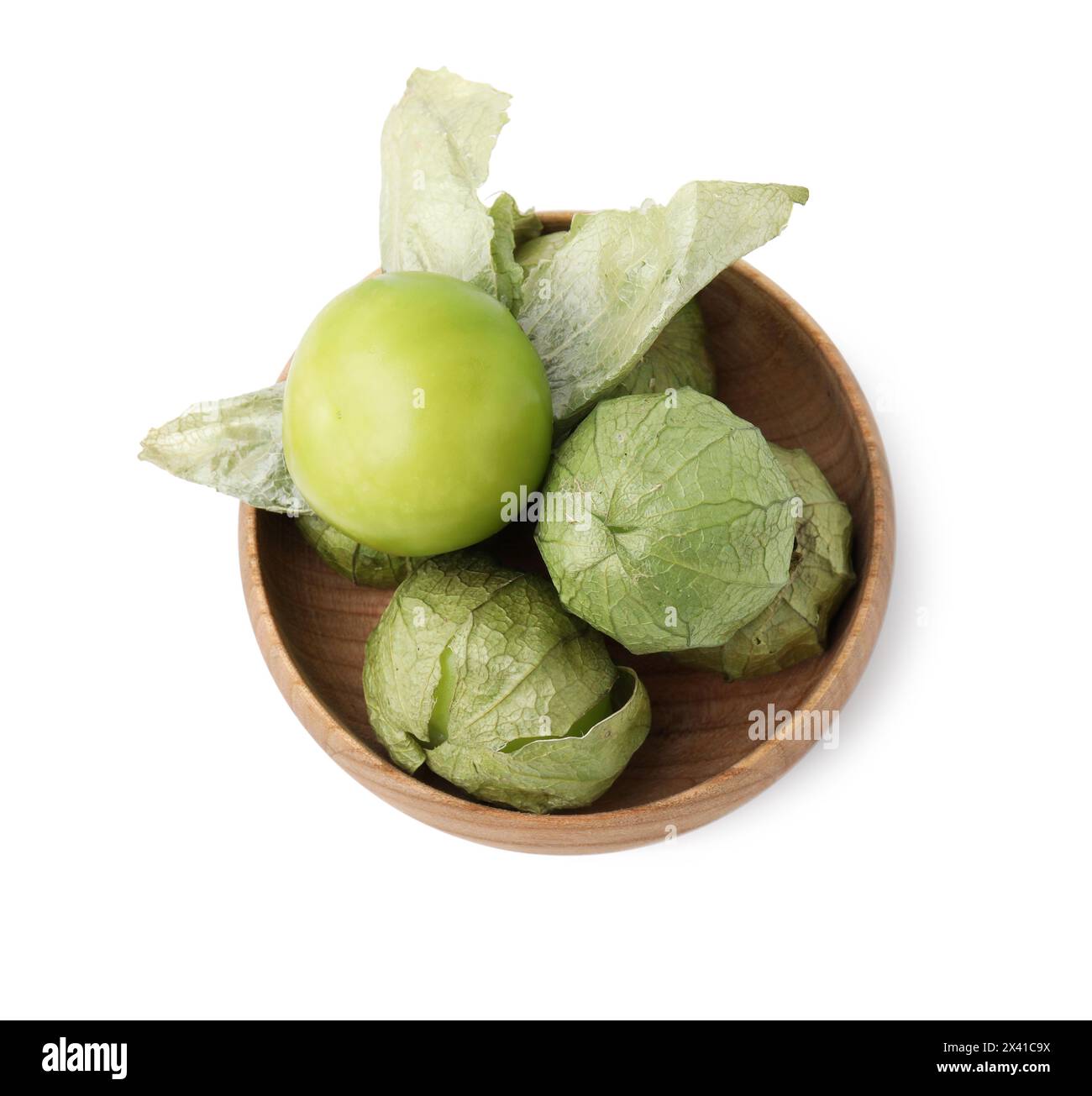 Bowl of fresh green tomatillos with husk isolated on white, top view ...