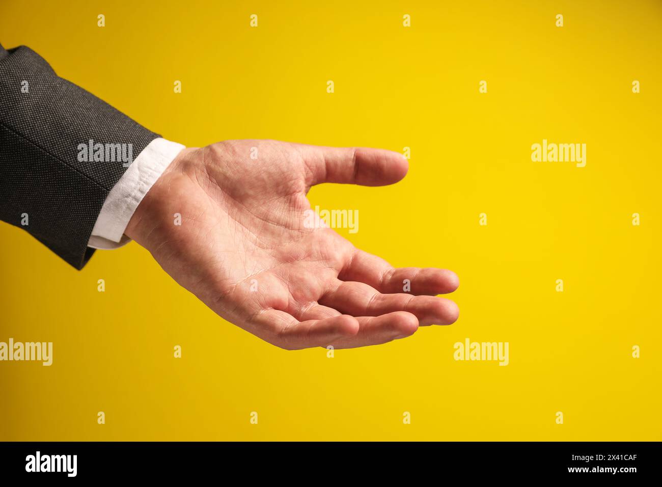 Man holding something in hand on yellow background, closeup Stock Photo ...