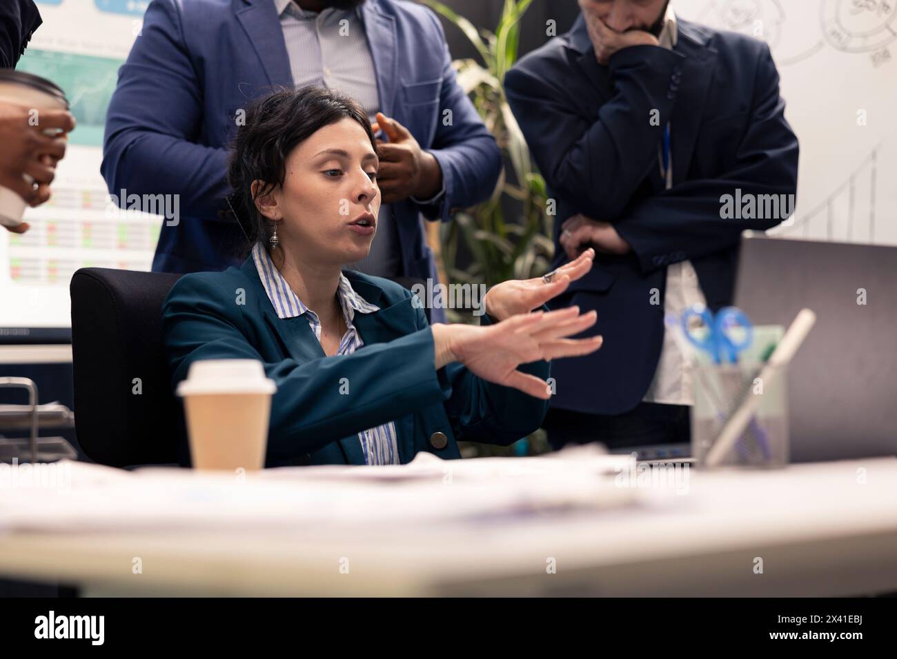 Dissatisfied angry supervisor reading the development project on laptop ...