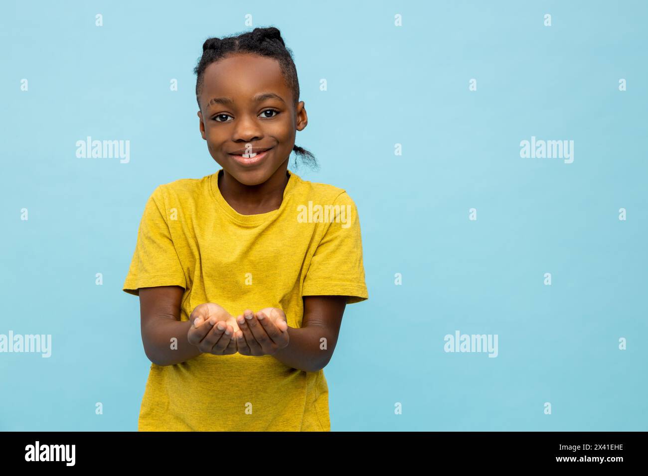 African american kid in yellow thsirt on blue background Stock Photo ...