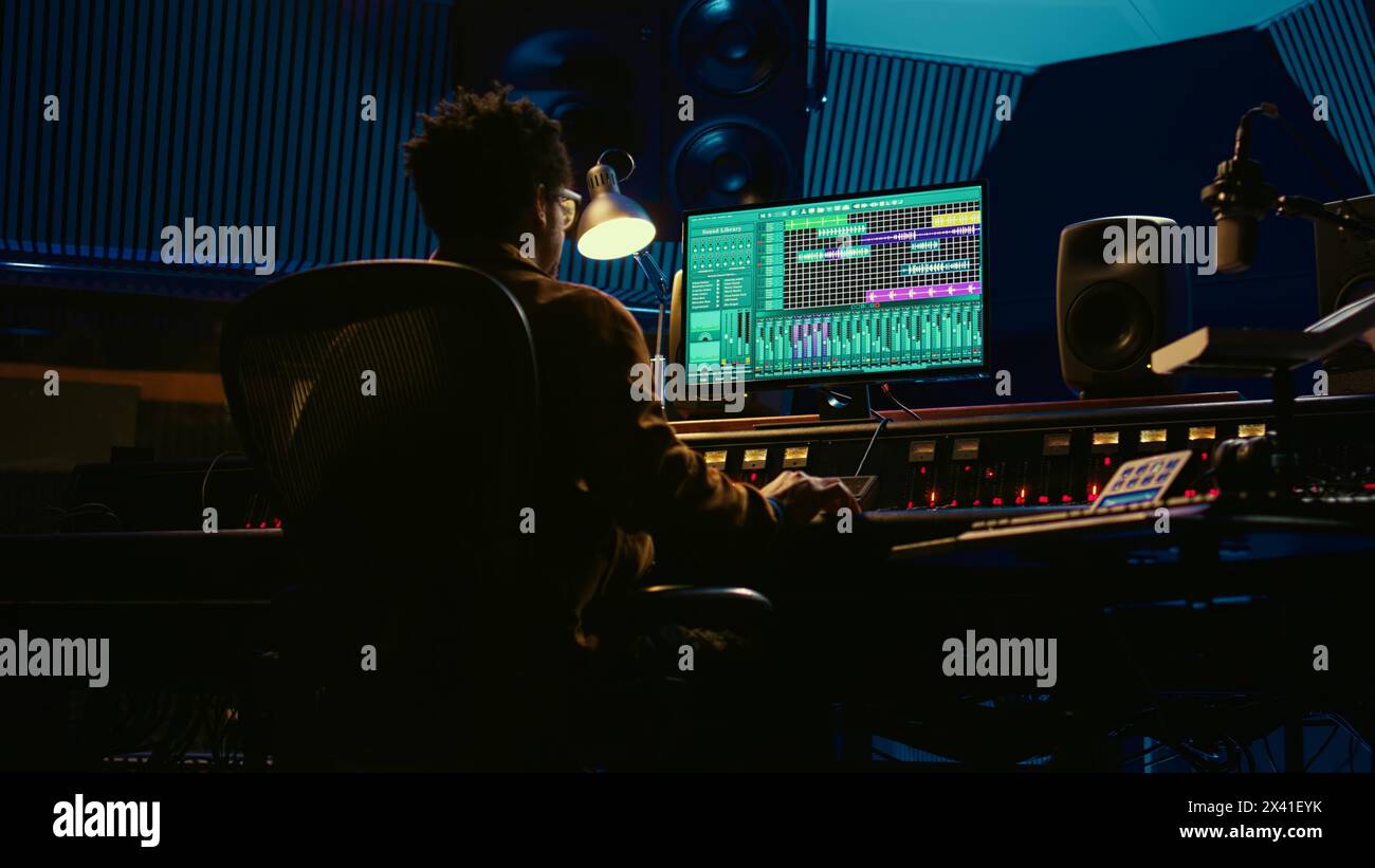 African american audio engineer uses compressor and mixer in ...