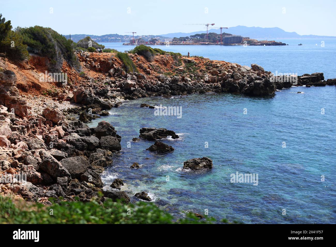 Strong winds drive ocean waves to the shore cliffs. A wide panorama ...