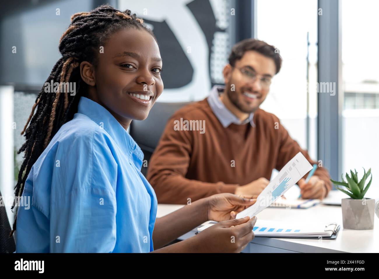 Multiracial coworkers cooperating working at office meeting Stock Photo ...