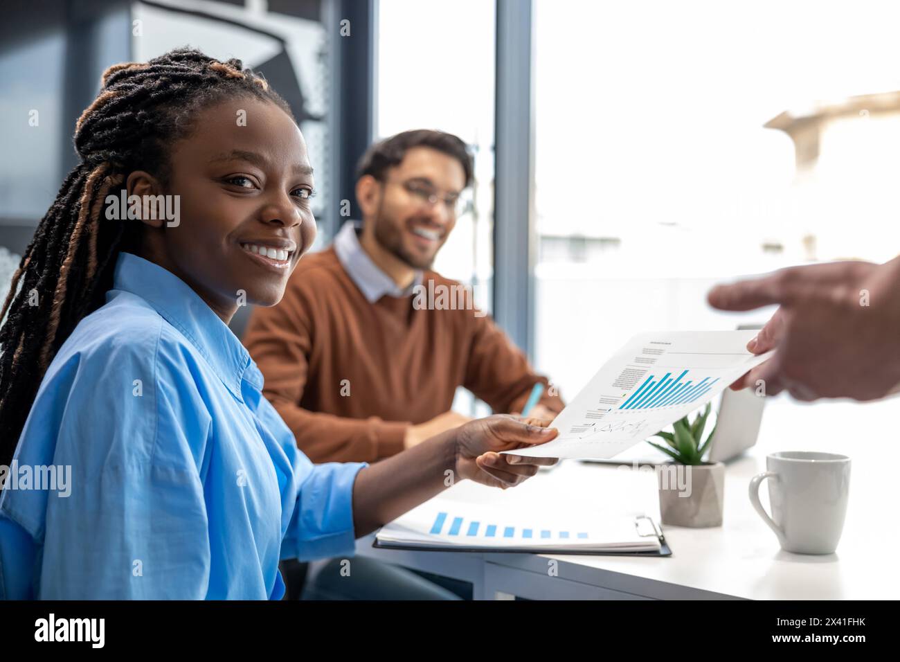 Multiracial coworkers cooperating working at office meeting Stock Photo ...