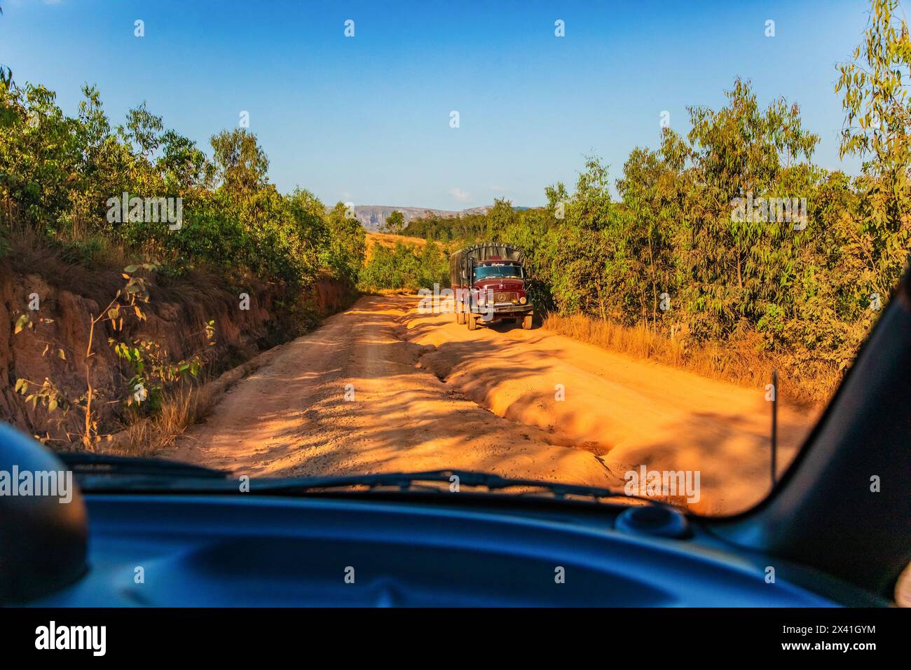 Madagascar 22. 10. 2023 .Red dust and mud road in poor condition with ...