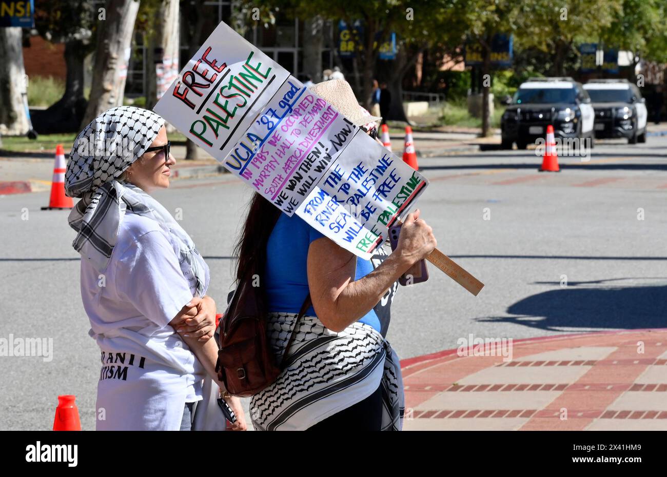 Pro-Palestinian demonstrators walk outside an encampment cordoned off ...