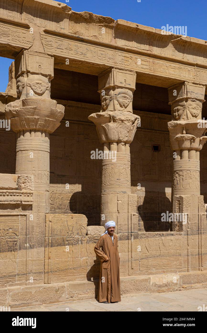 An Egyptian man in traditional attire inside the Temple of Isis at the ...