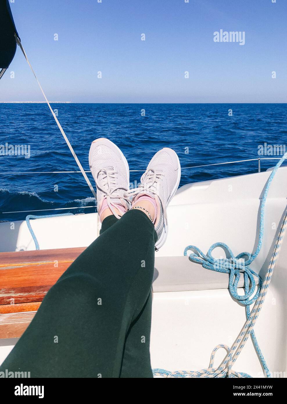 Young faceless woman is sunbathing relaxing on a yacht in summertime ...