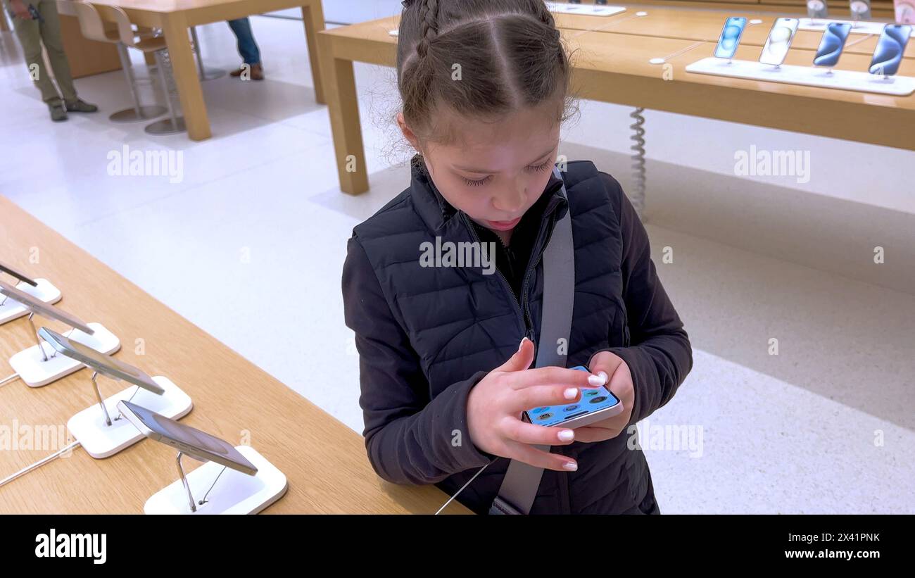 Little Girl Exploring New iPhones at Apple Store in Park Meadows Mall ...