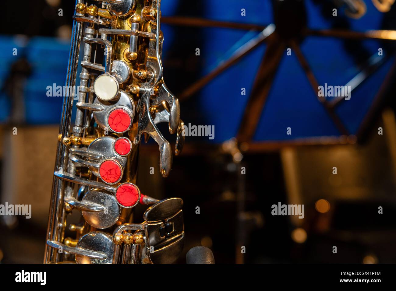 A small red and gold instrument with a black and gold handle Stock ...