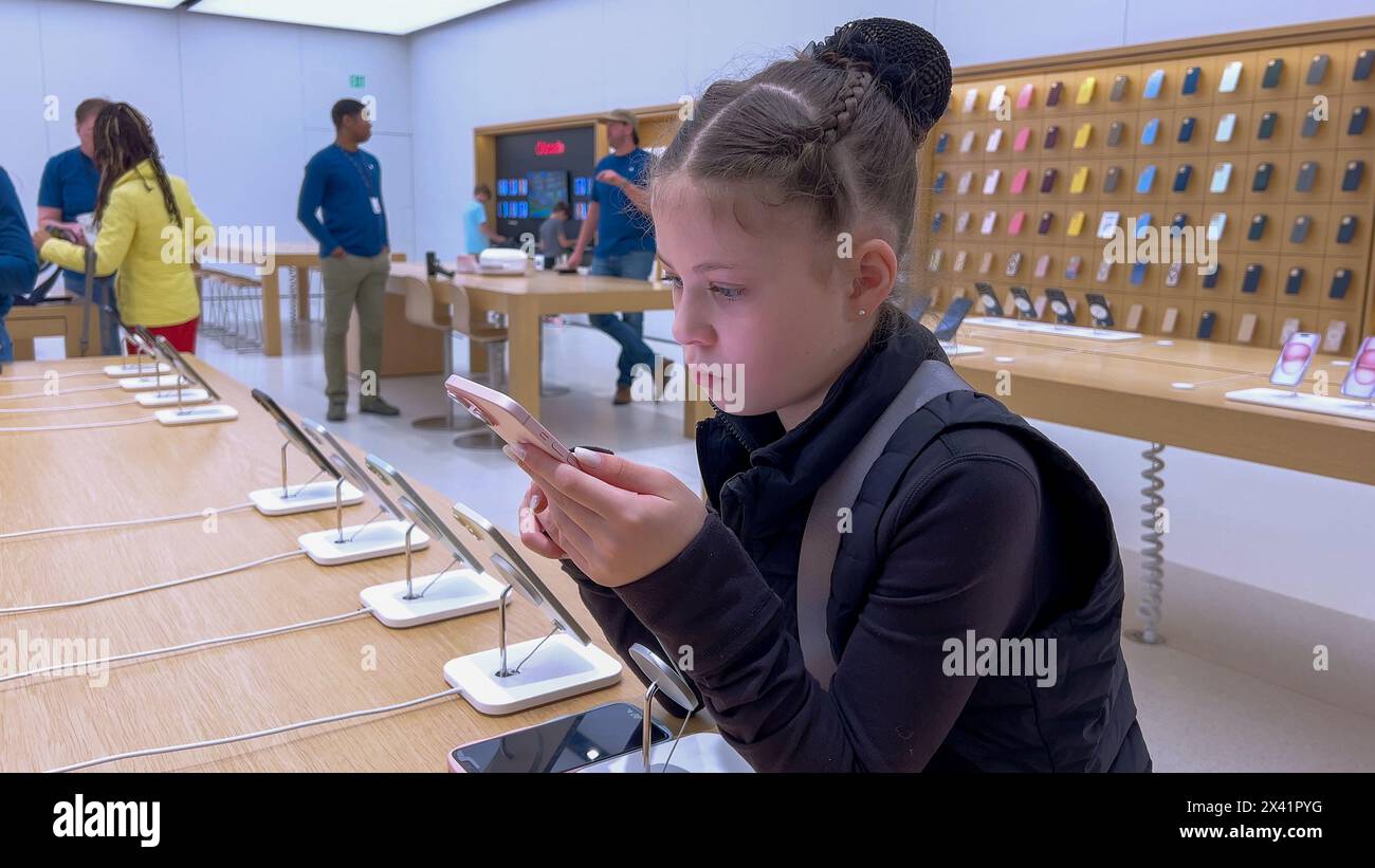 Little Girl Exploring New iPhones at Apple Store in Park Meadows Mall ...