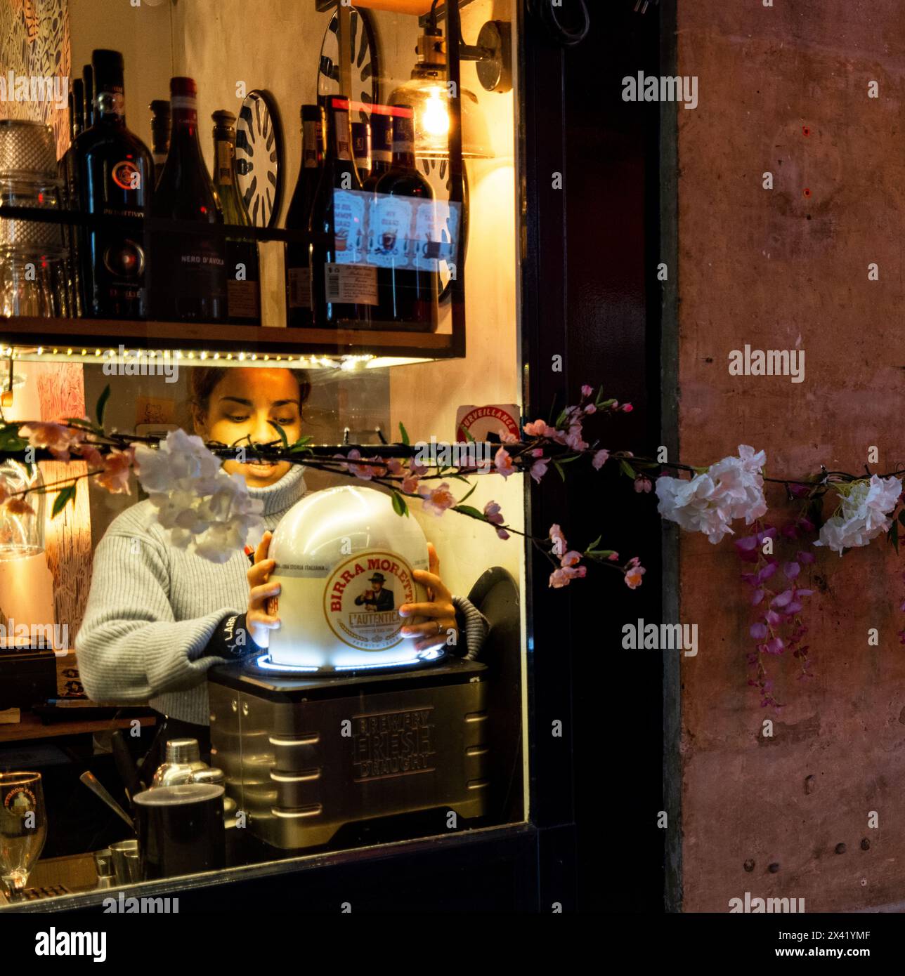 Upmarket chic café in Paris, showing a waitress preparing food through ...