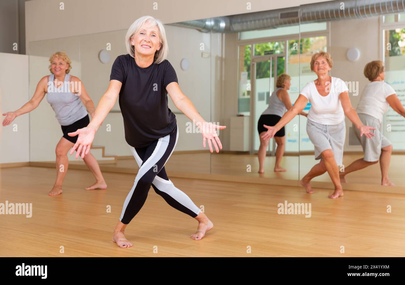 Positive aged woman practicing vigorous dance movements Stock Photo - Alamy