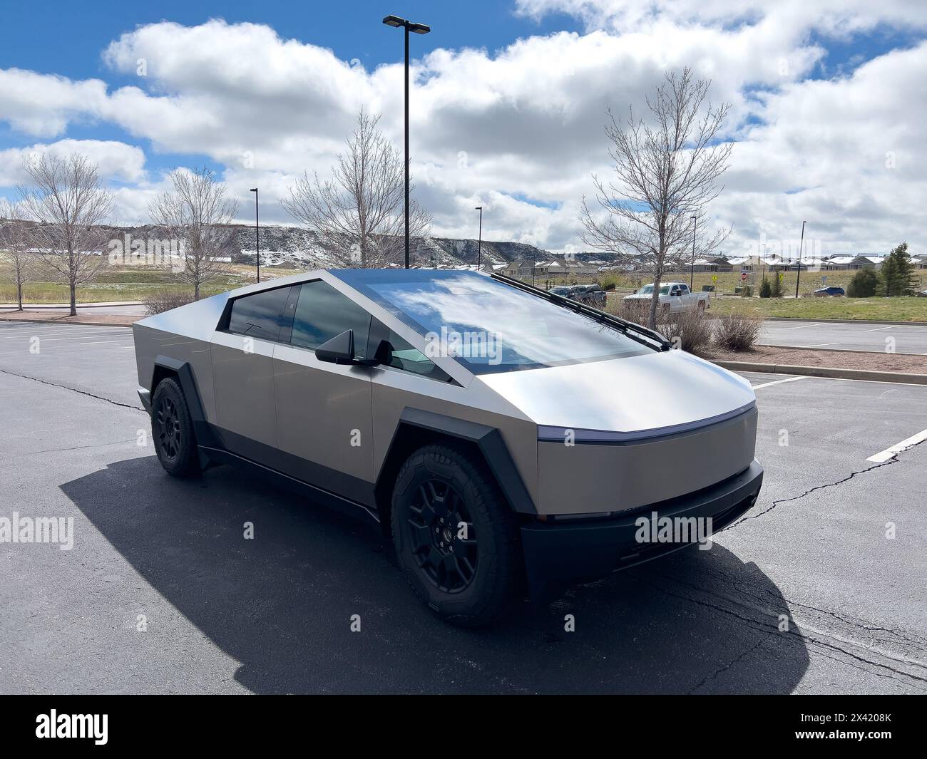 Side View of a Tesla Cybertruck in a Spacious Outdoor Parking Area ...