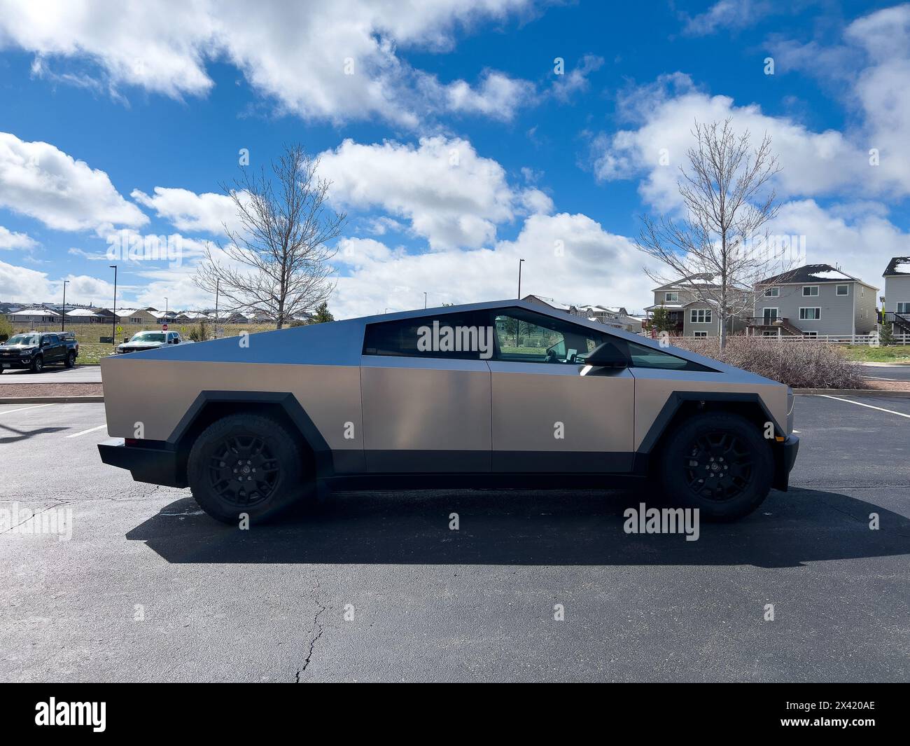 Side View of a Tesla Cybertruck in a Spacious Outdoor Parking Area ...
