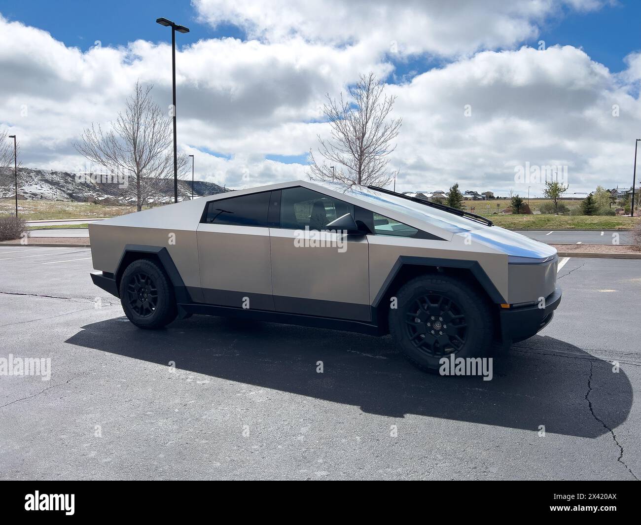Side View of a Tesla Cybertruck in a Spacious Outdoor Parking Area ...