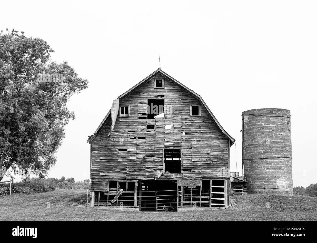 Old Farm Barn and Silo in poor condition in black and white image with ...