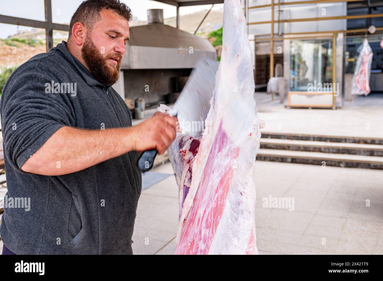 butchery selling fresh meat from hanging lamb outdoor Stock Photo - Alamy