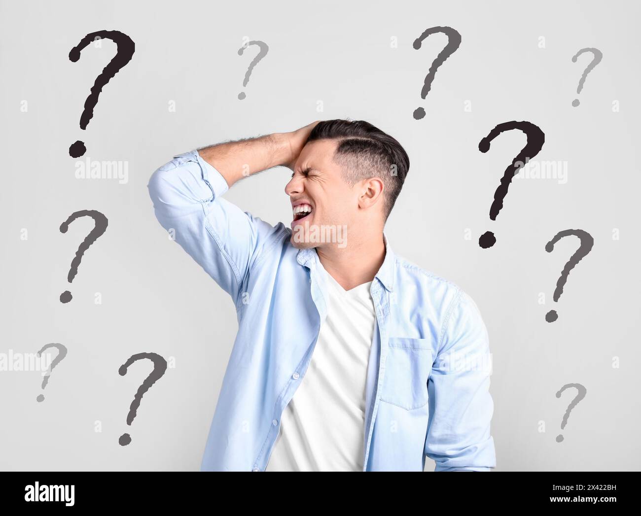 Amnesia. Stressed man and question marks on light background Stock ...