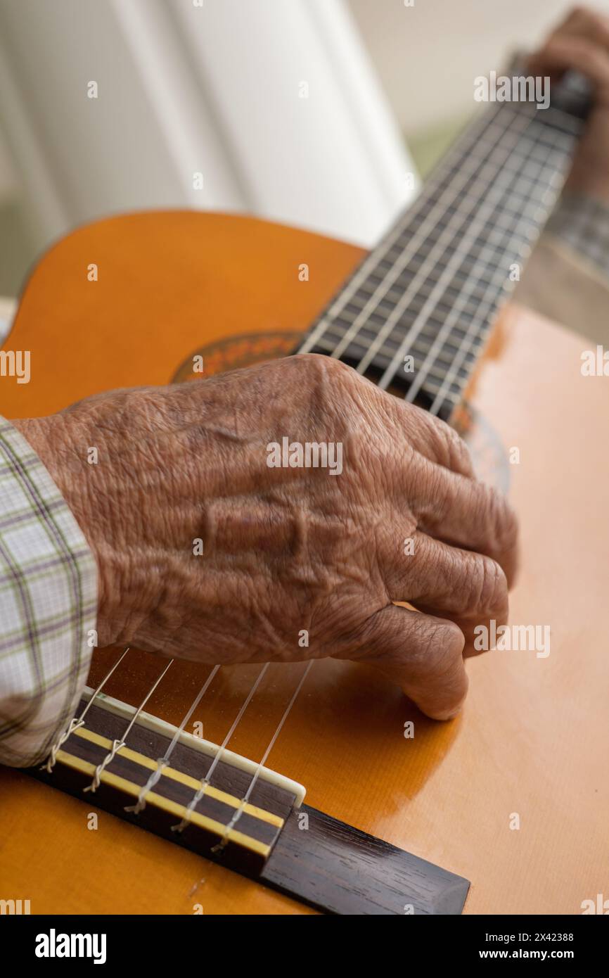 classical guitar, hands of a person playing musical instruments with ...