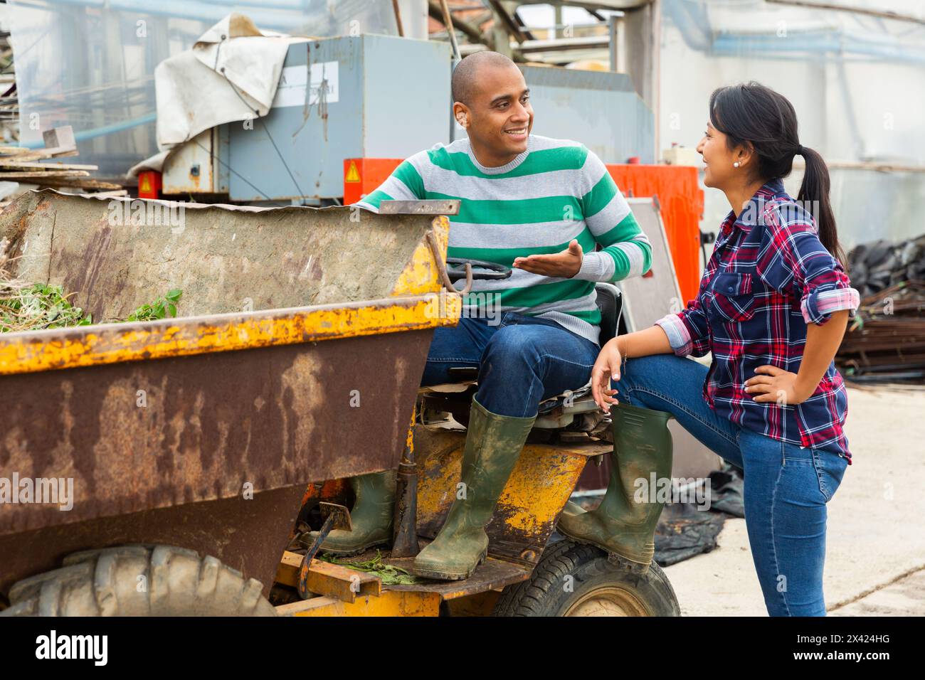 Latin american farmer a man driving a mini dump truck, communicates ...