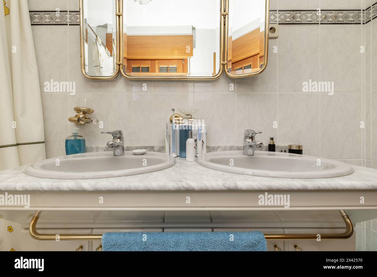 Old bathroom with two sinks integrated into the marble countertop and ...