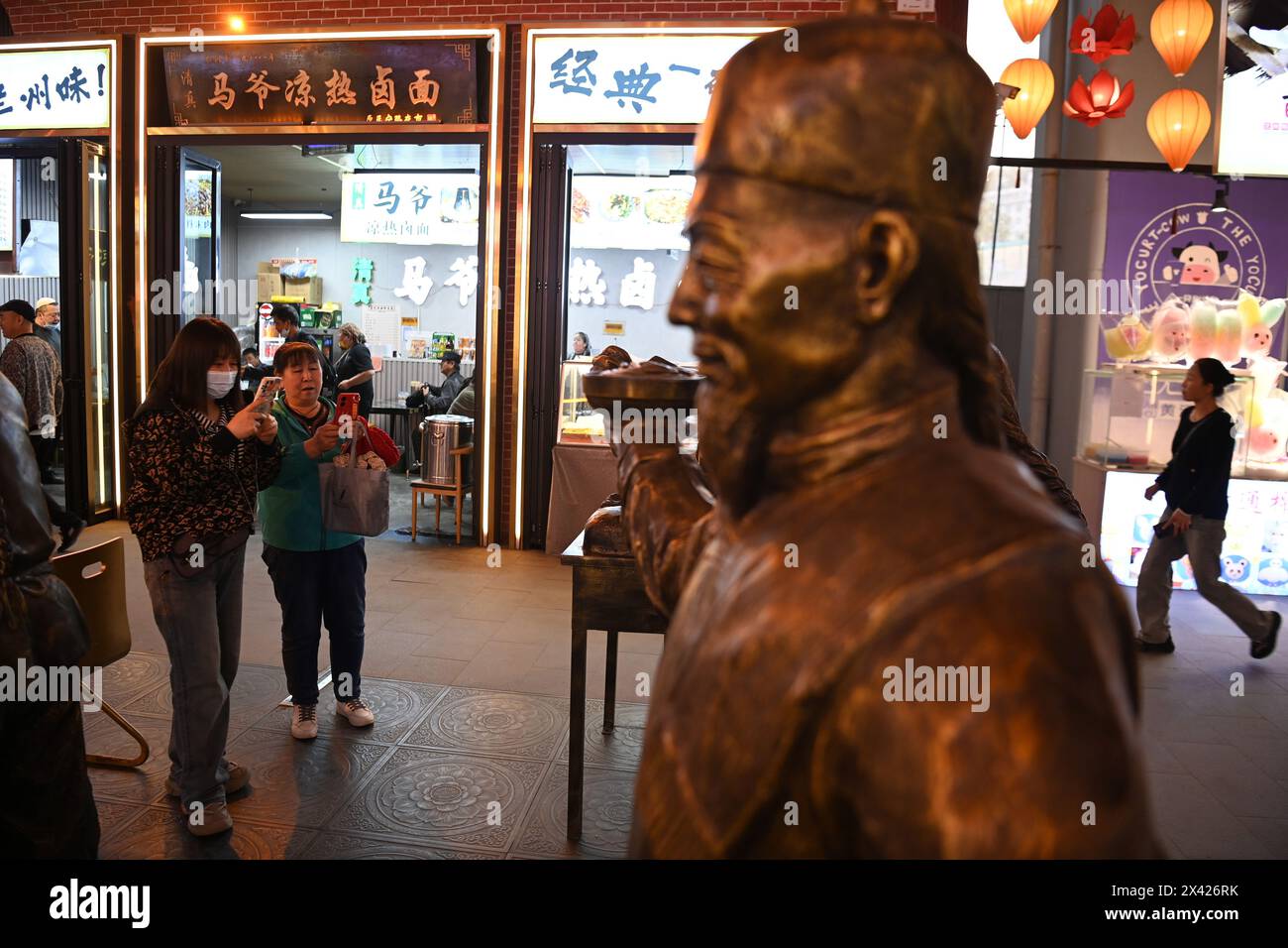 Lanzhou, China's Gansu Province. 26th Apr, 2024. Tourists take photos ...