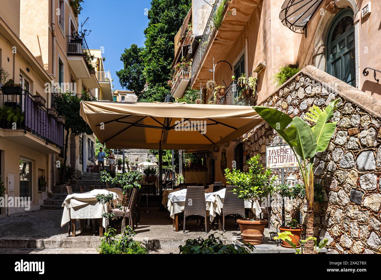 Rome, Italy - July 16 2023: View of old stone buildings with potted ...
