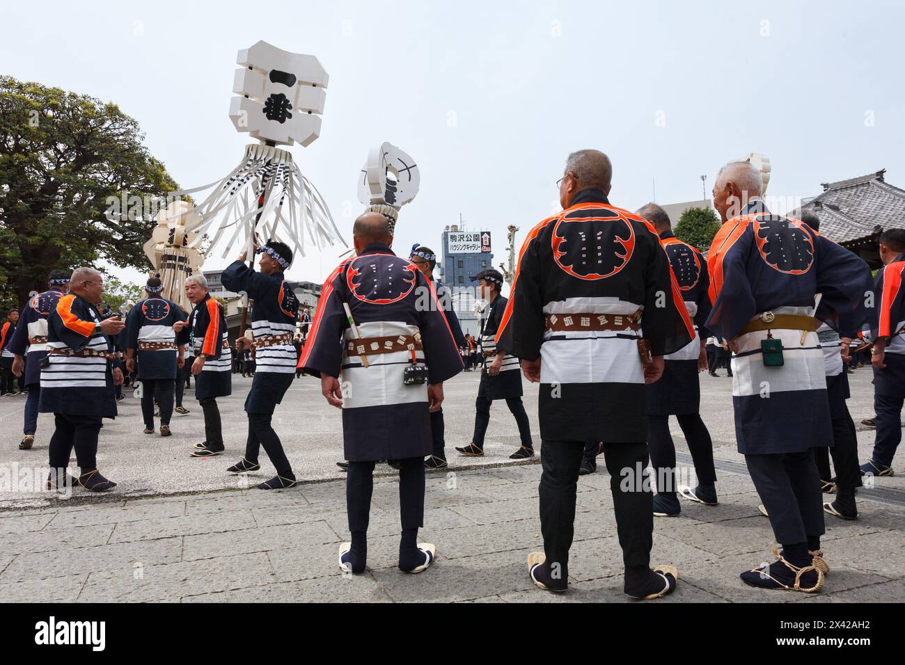 Tokyo, Japan. 29th Apr, 2024. A parade of men wearing festival jackets ...