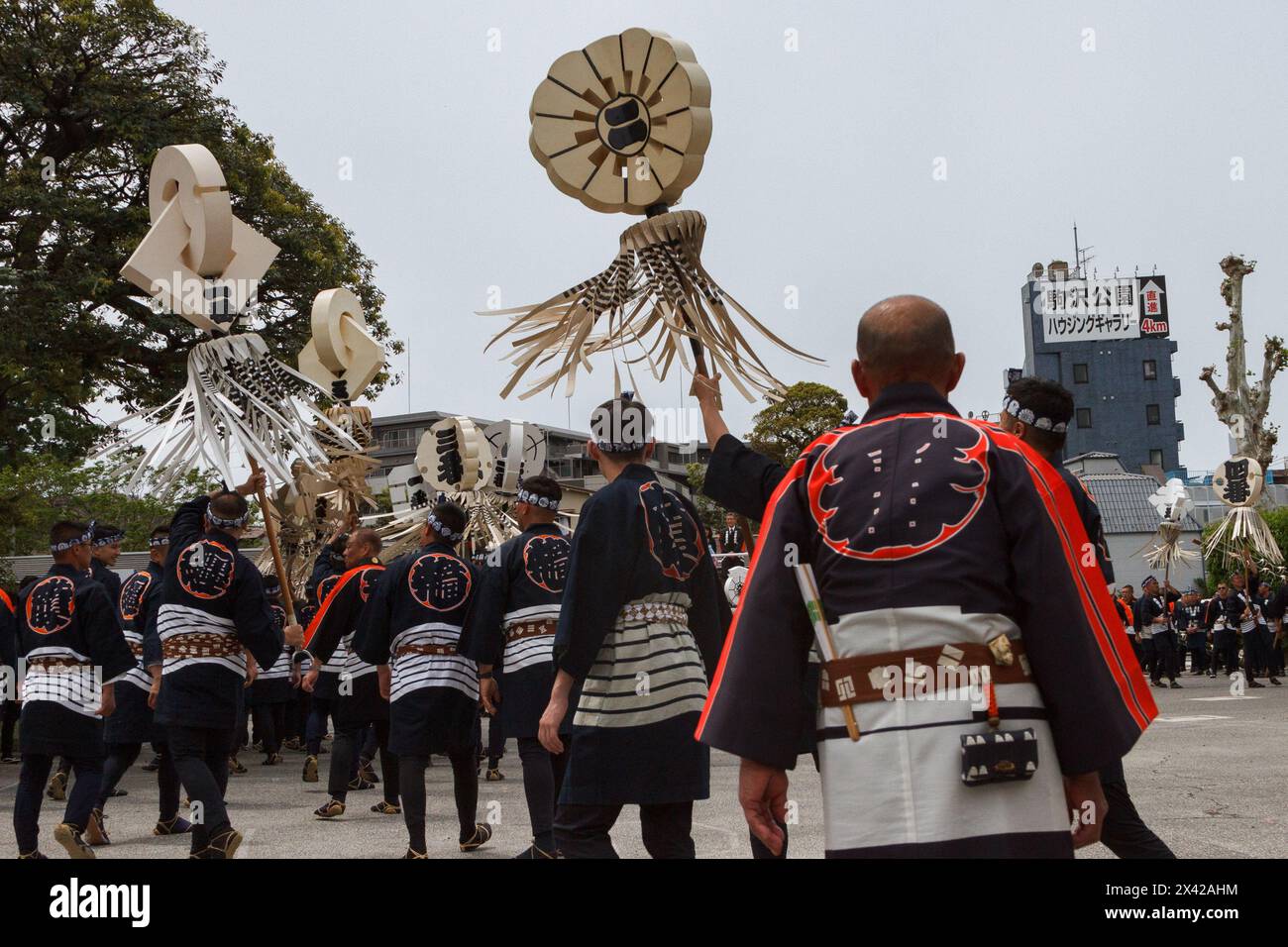 Tokyo, Japan. 29th Apr, 2024. A parade of men wearing festival jackets ...