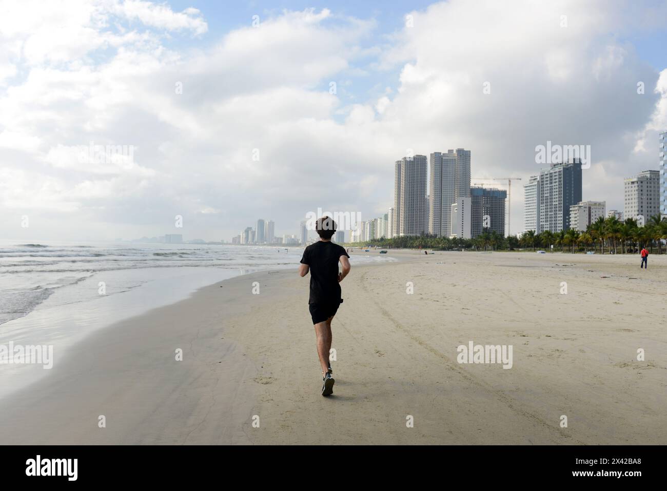 The beautiful long white sand beach along the changing waterfront ...