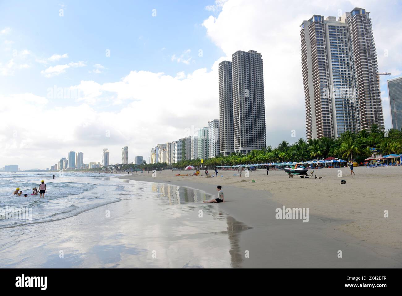 The beautiful long white sand beach along the changing waterfront ...