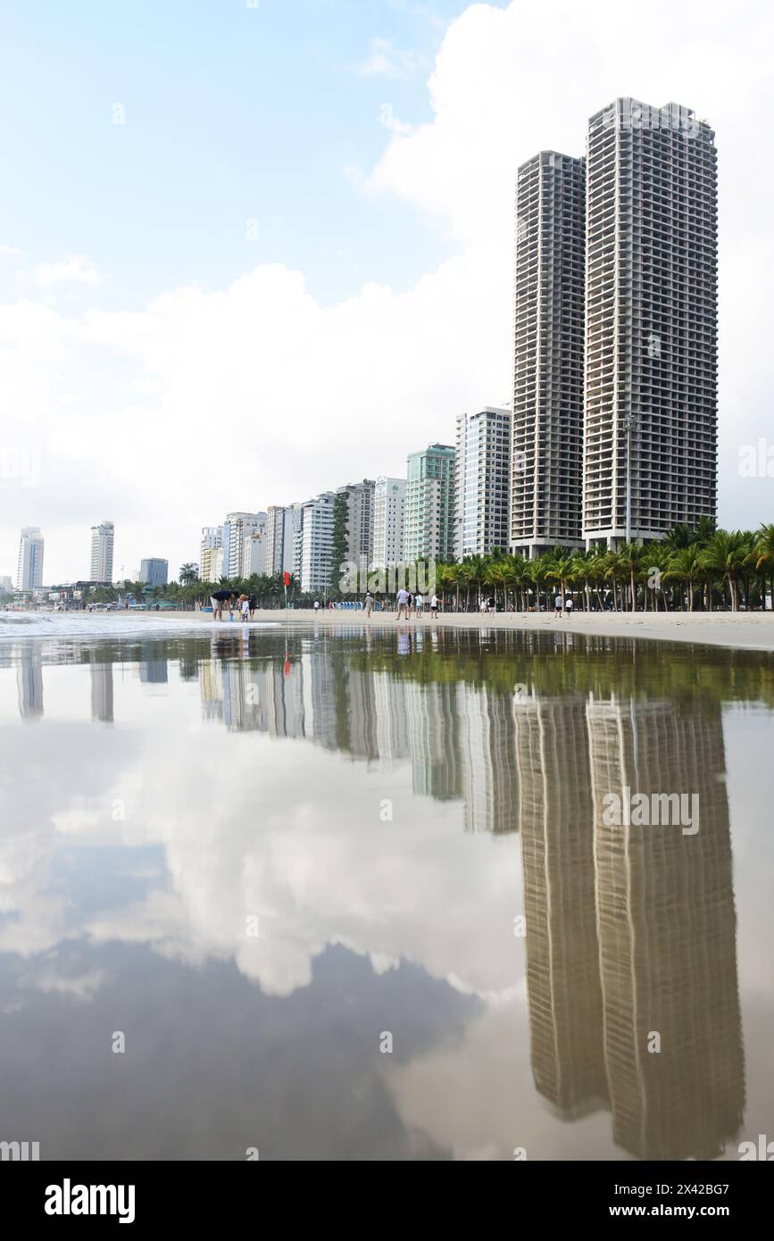 The beautiful long white sand beach along the changing waterfront ...