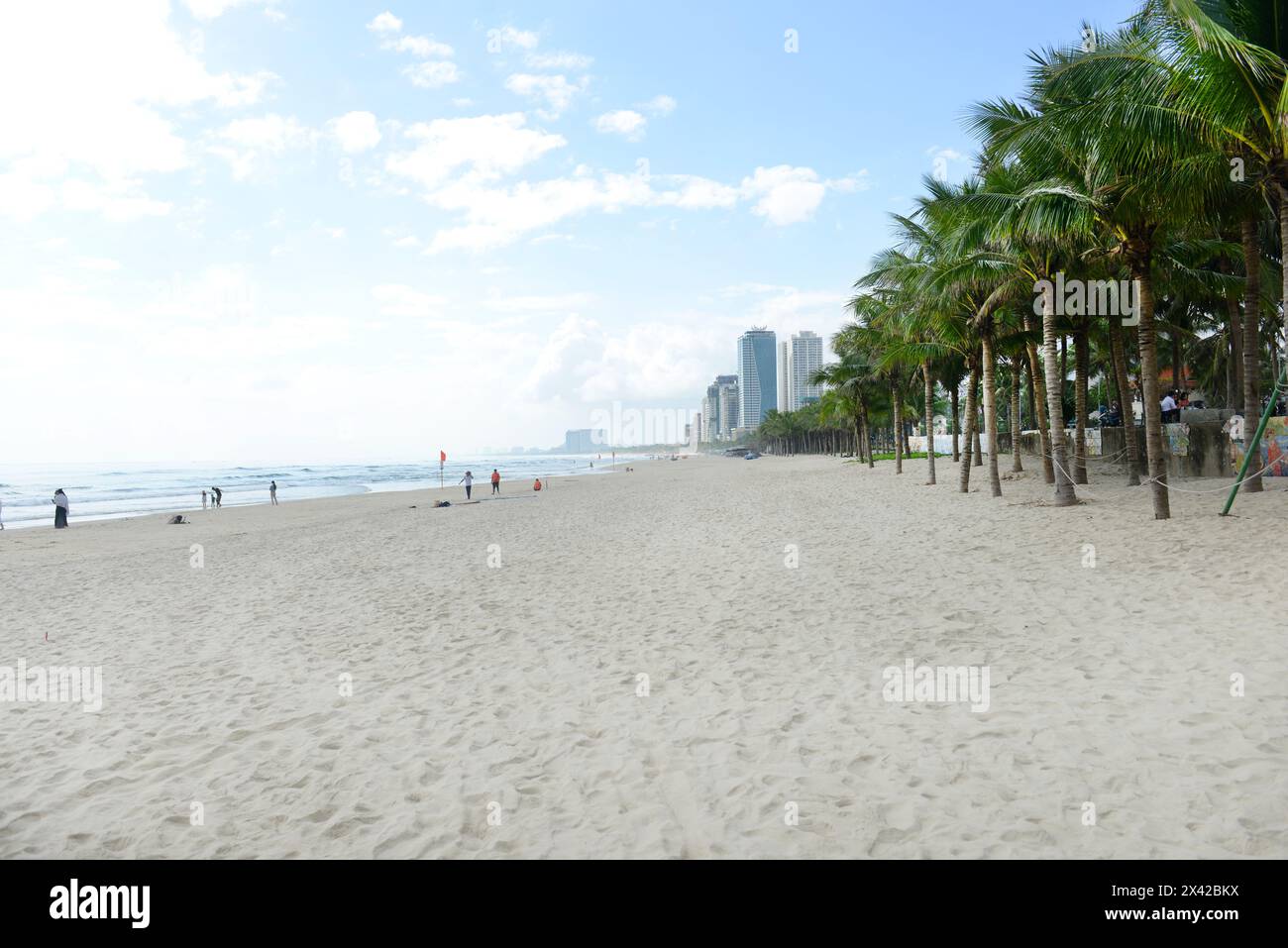 The beautiful long white sand beach along the changing waterfront ...