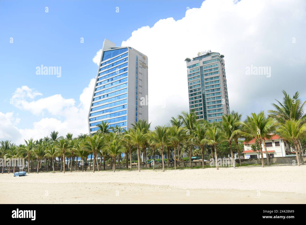 The beautiful long white sand beach along the changing waterfront ...