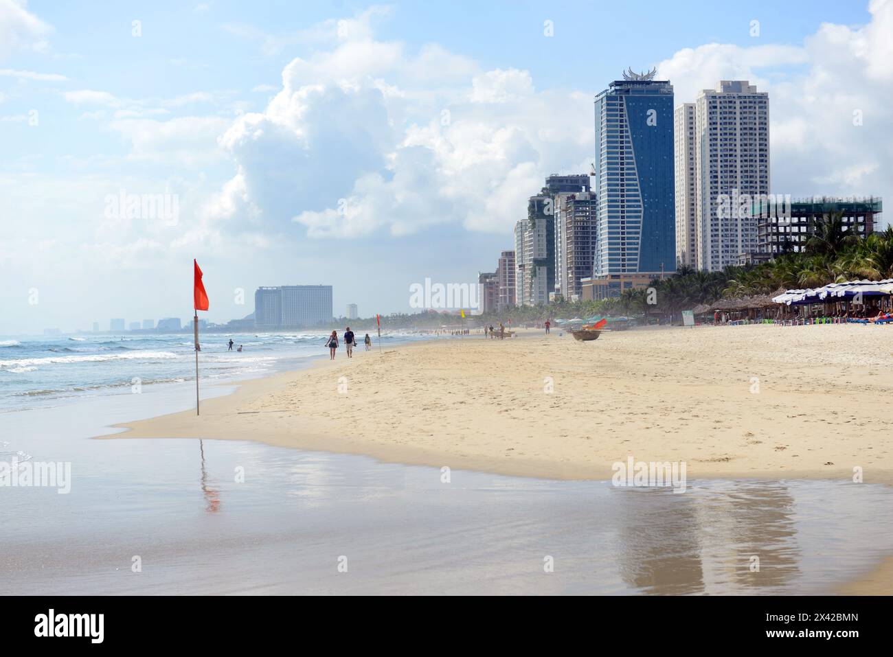 The beautiful long white sand beach along the changing waterfront ...