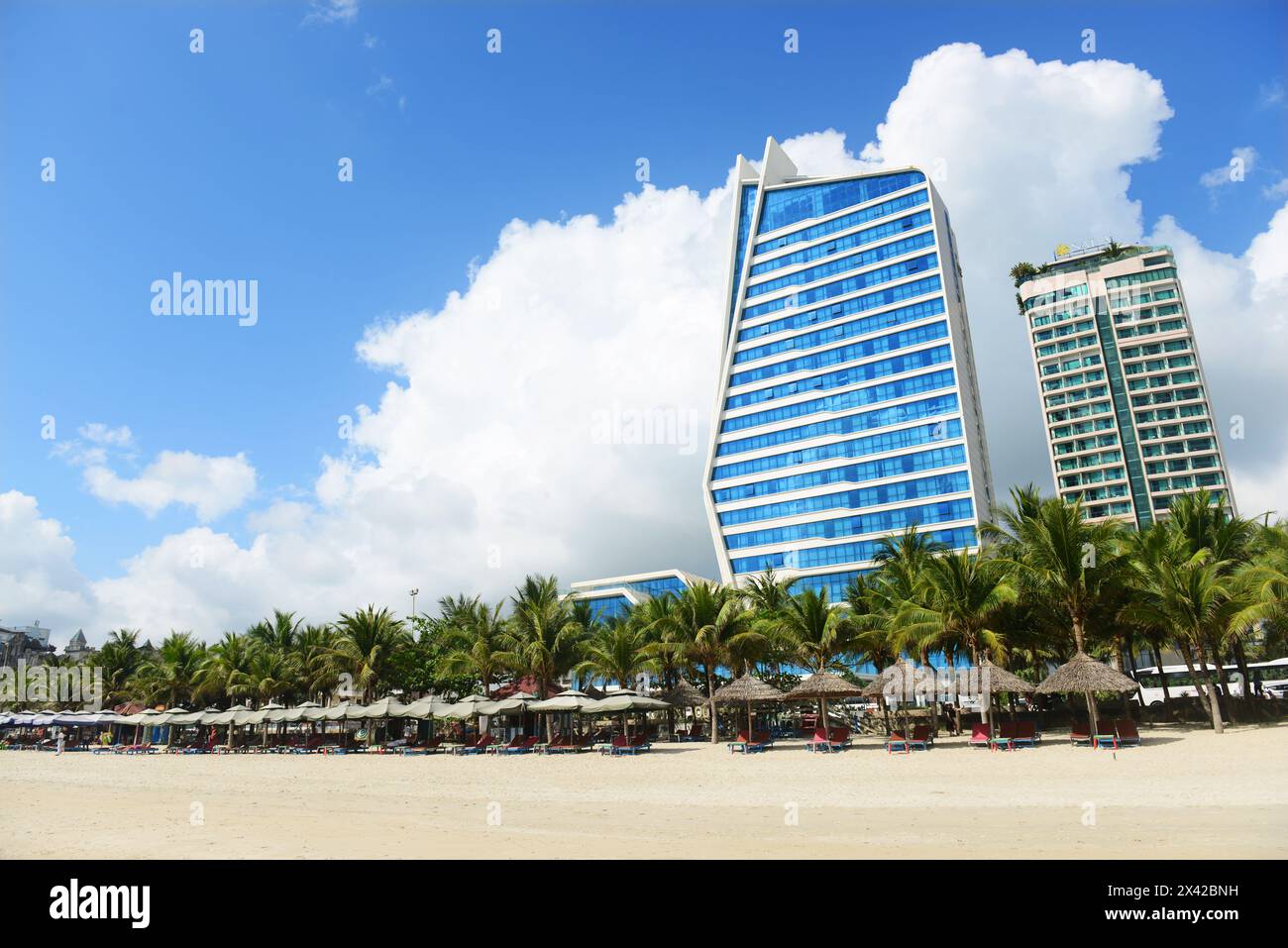 The beautiful long white sand beach along the changing waterfront ...