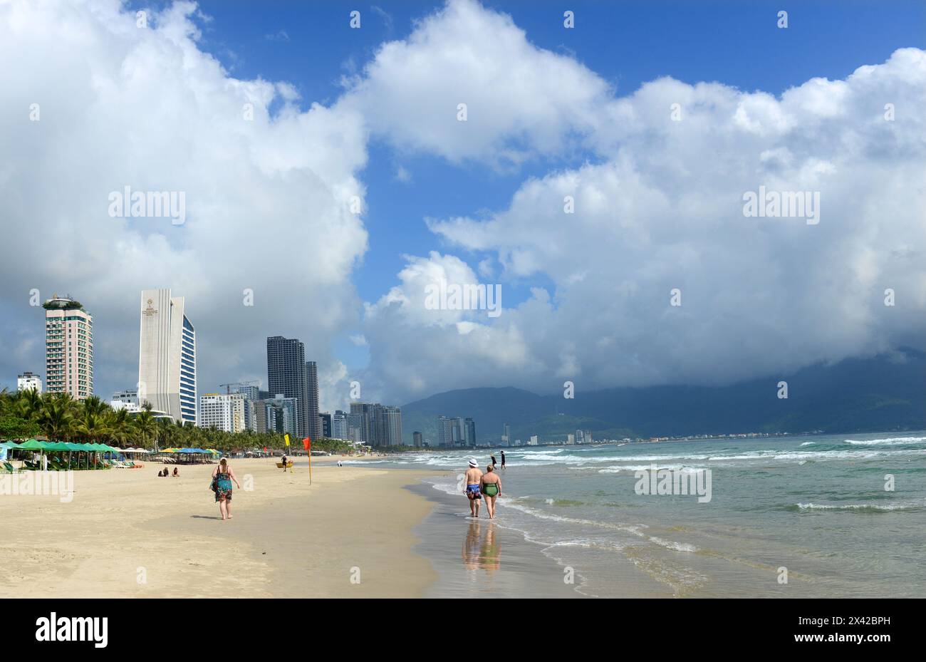 The beautiful long white sand beach along the changing waterfront ...
