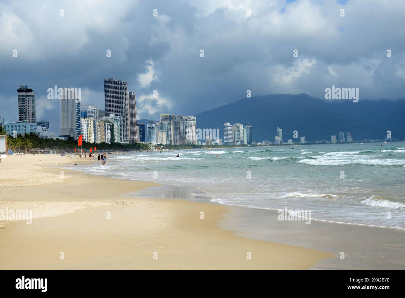 The beautiful long white sand beach along the changing waterfront ...