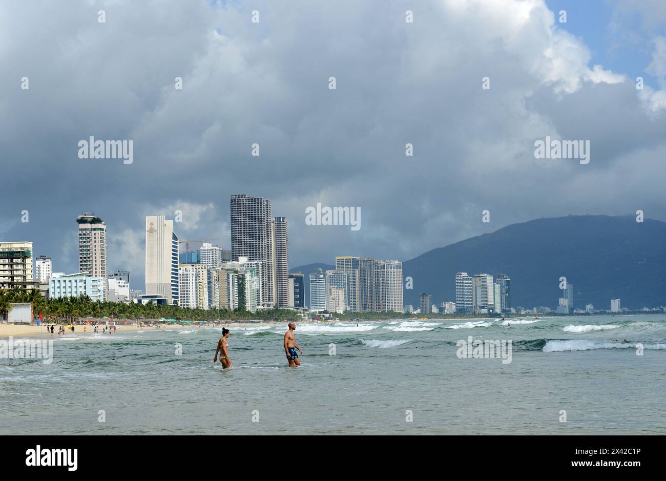 The beautiful long white sand beach along the changing waterfront ...