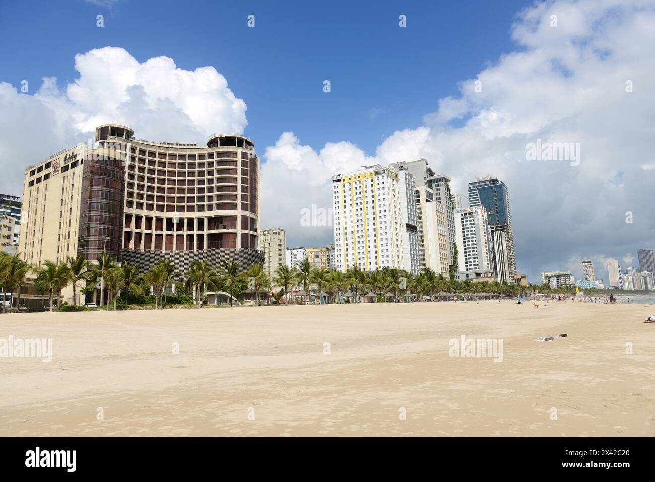 The beautiful long white sand beach along the changing waterfront ...