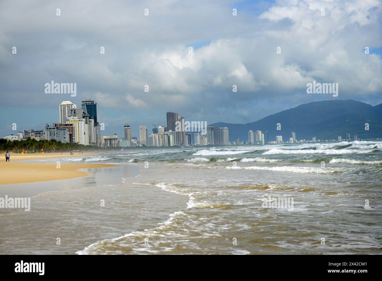 The beautiful long white sand beach along the changing waterfront ...