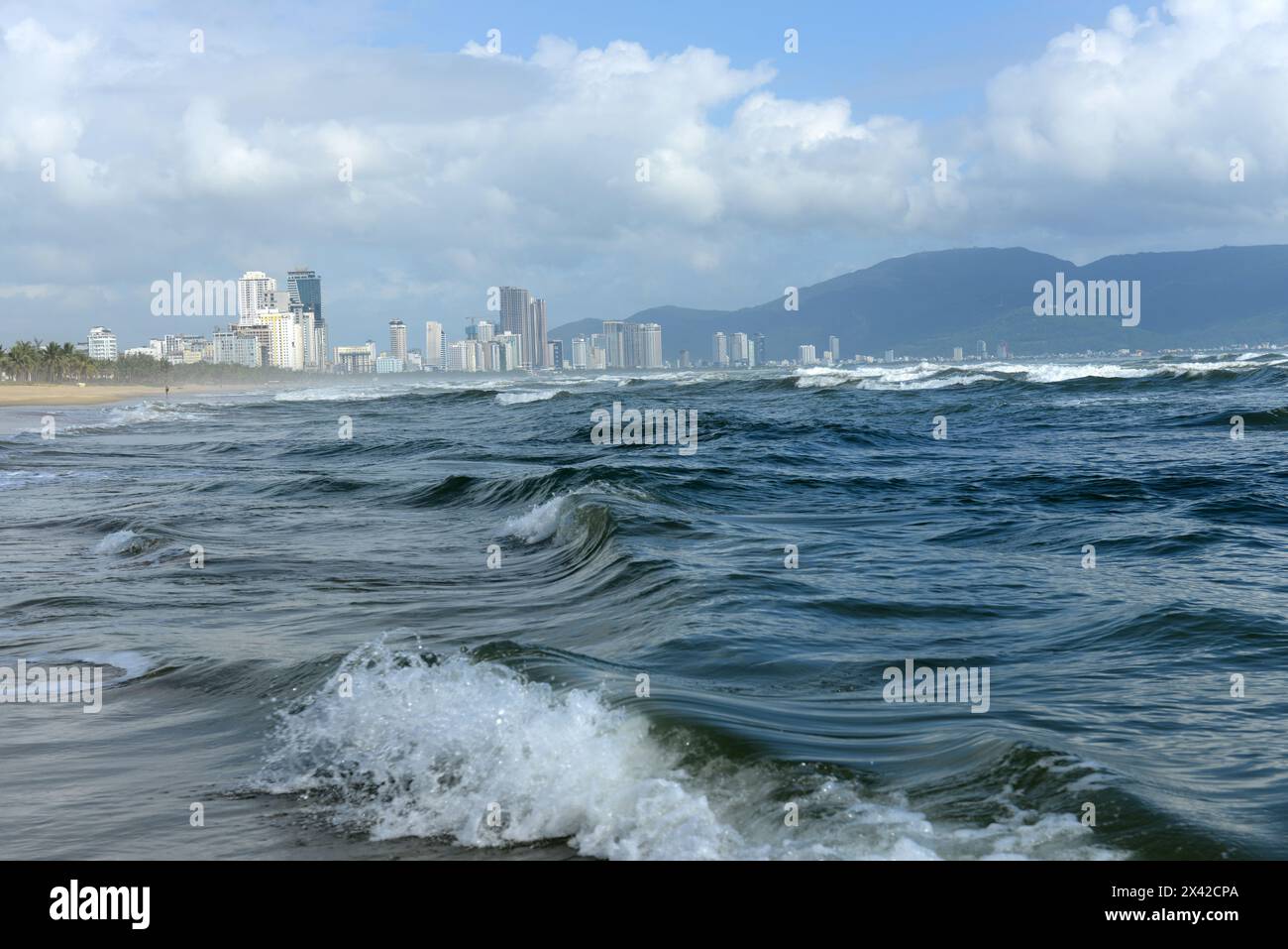 The beautiful long white sand beach along the changing waterfront ...
