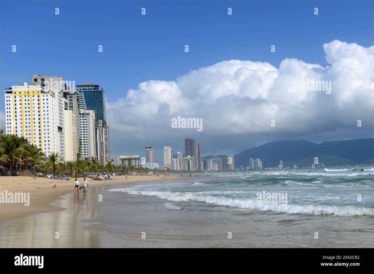 The beautiful long white sand beach along the changing waterfront ...