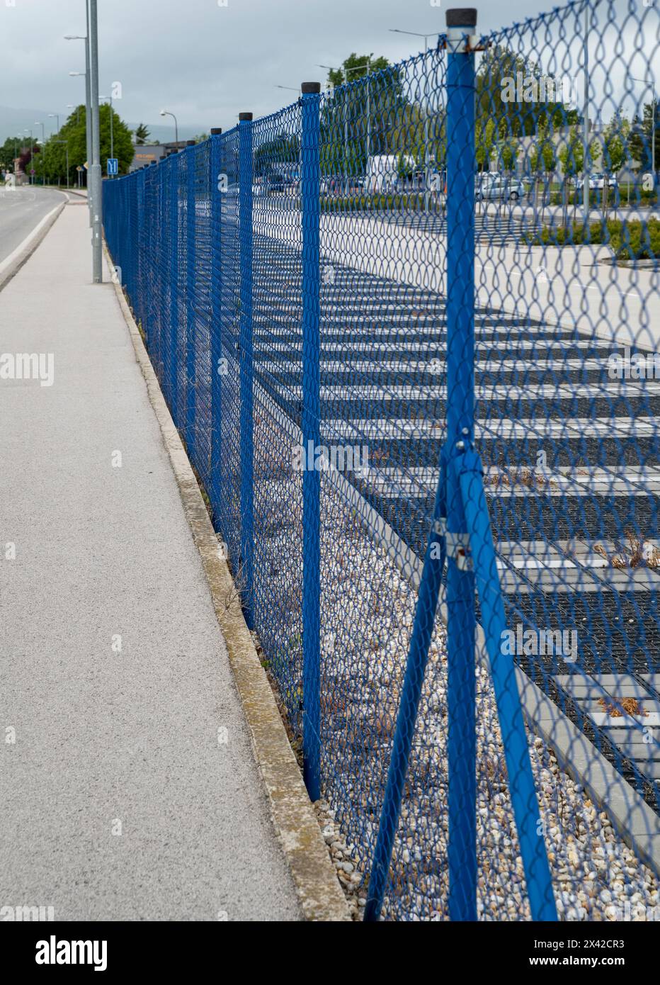 Blue steel wire mesh fence around the protected area. Restricted area ...