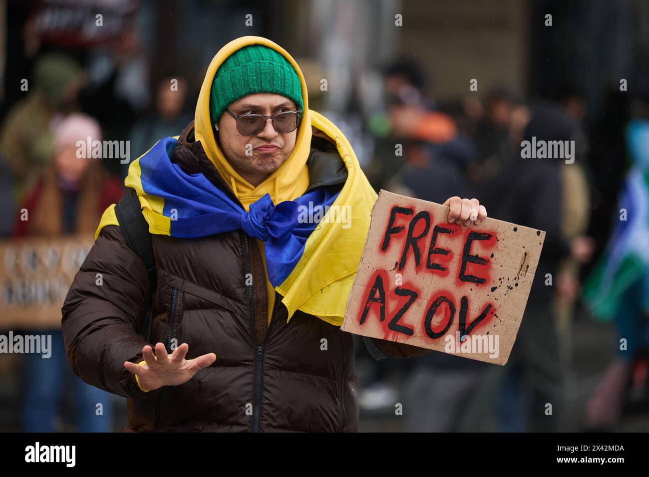 Patriotic Ukrainian man walks with a banner "Free Azov" on a public ...
