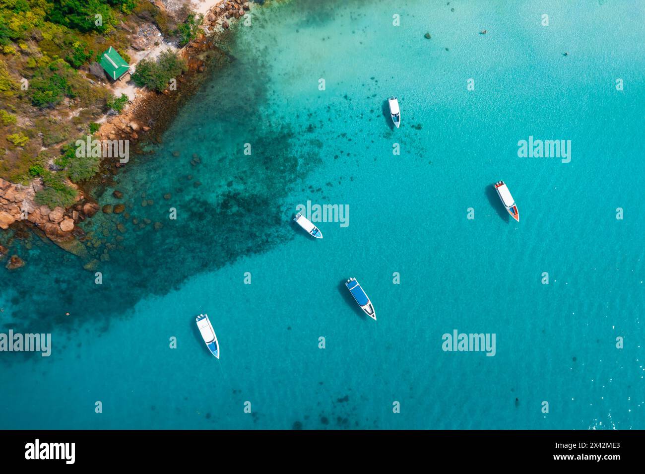 Speedboats and ship around a tropical paradise exotic island in the ...