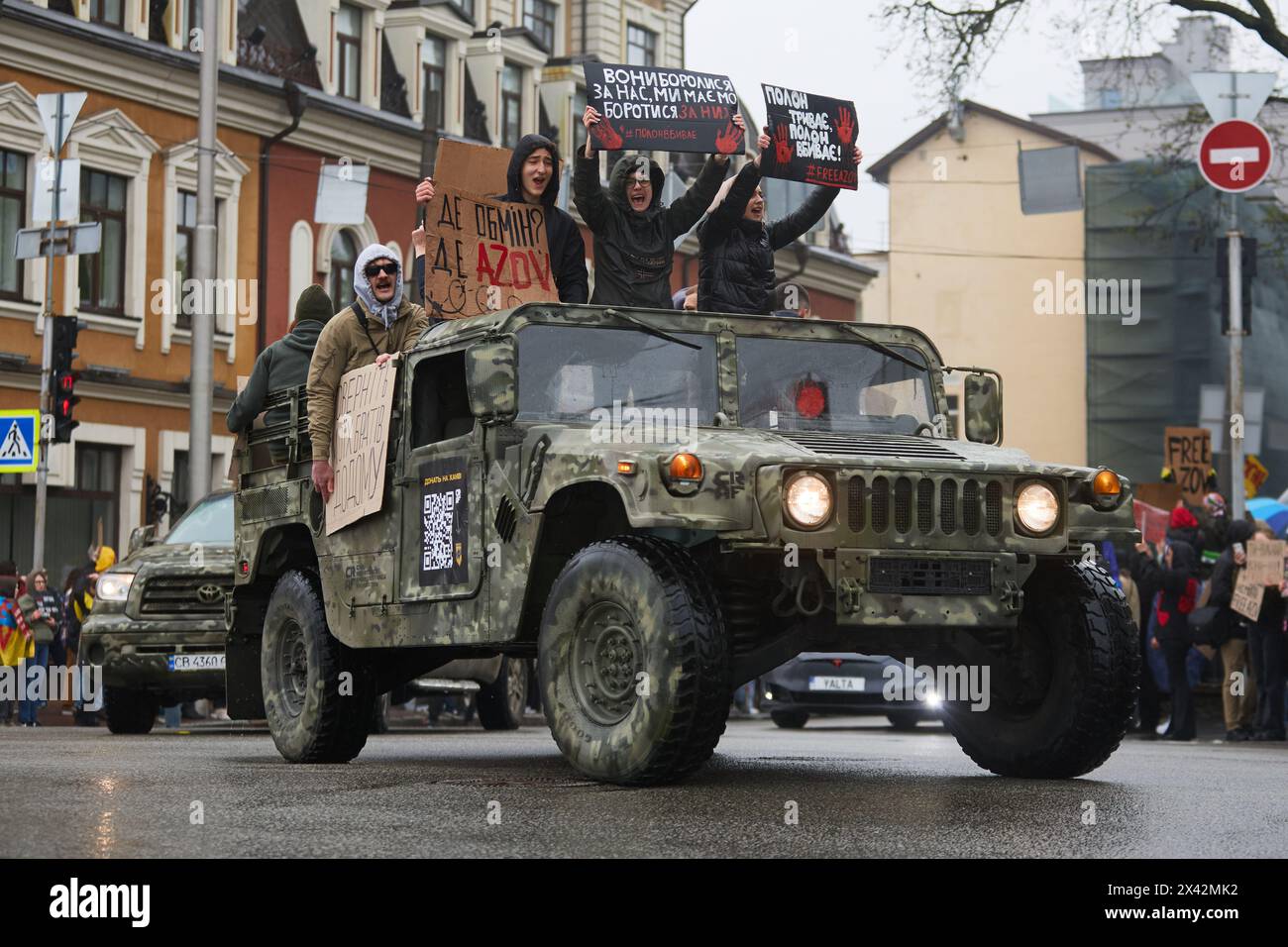Ukrainian activists riding on a HMMW Humvee truck with banners "Free ...